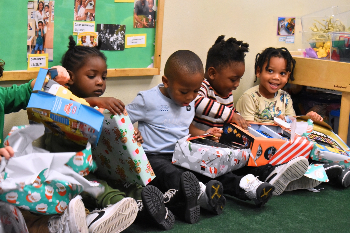 ECS4Kids children tear open Christmas gifts
